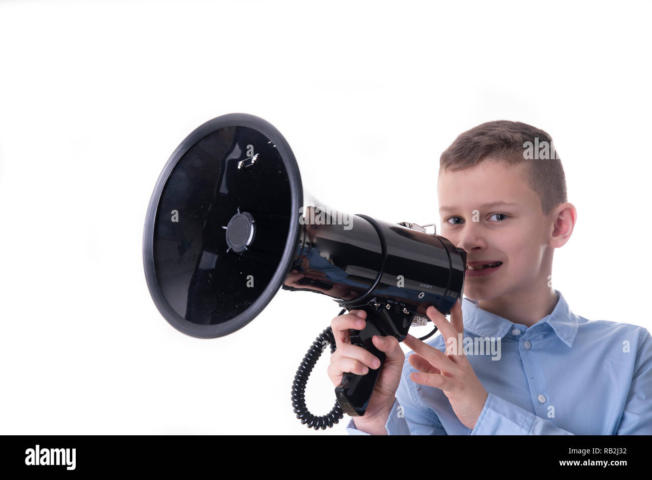 Boy calls into a megaphone and announces something on white background ...