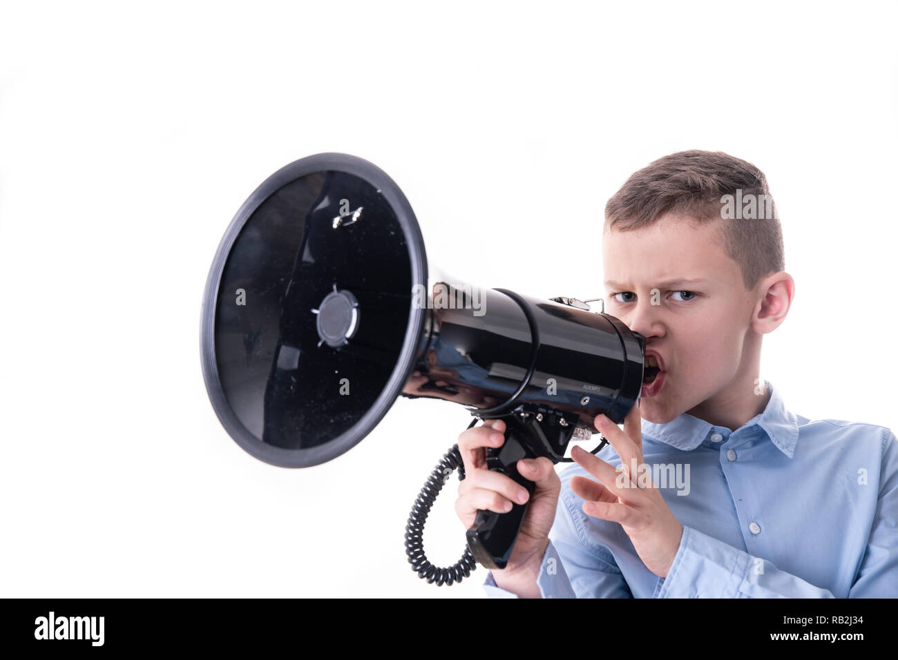 Boy calls into a megaphone and announces something on white background ...