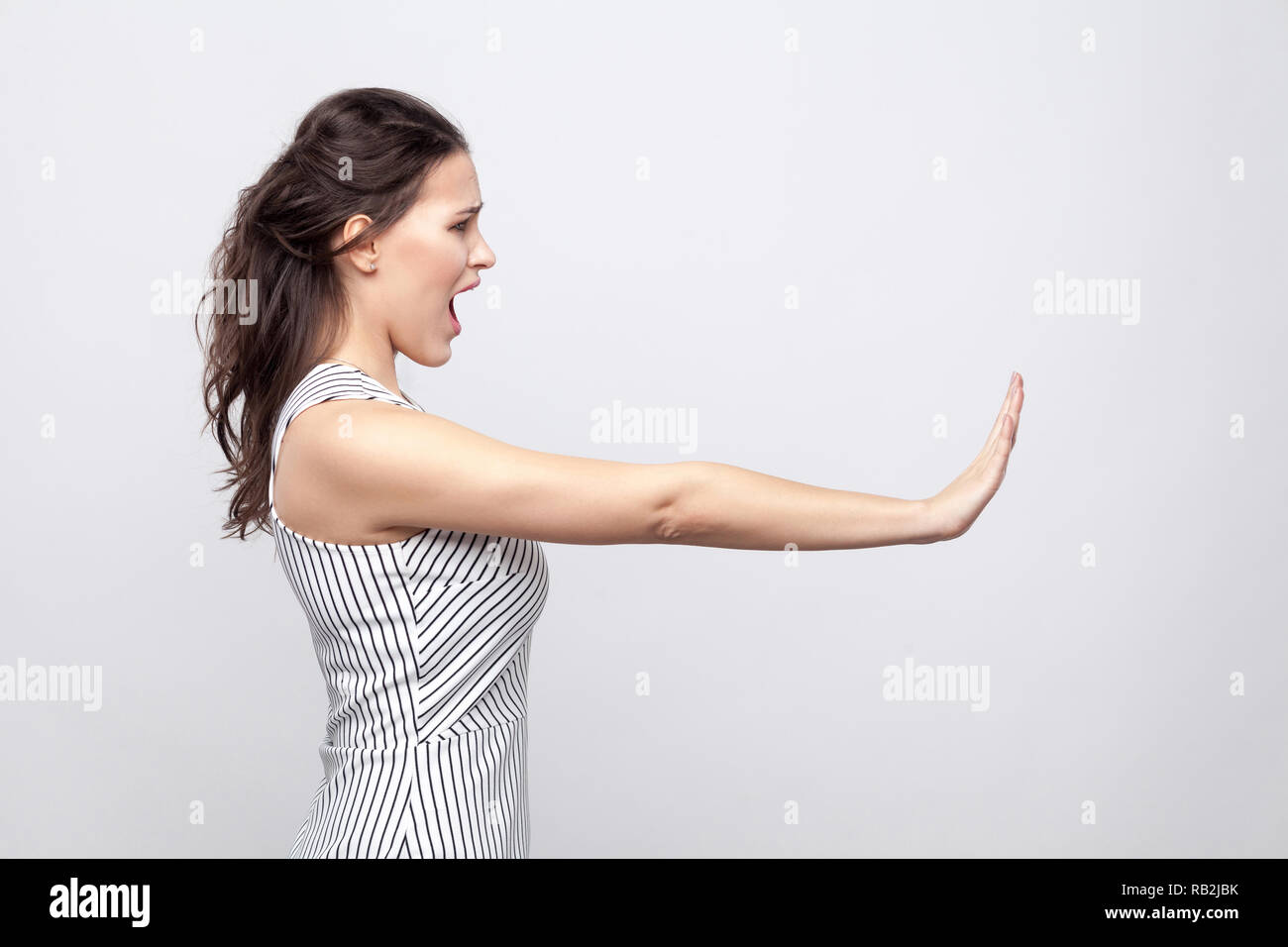 Profile side view portrait of angry beautiful young brunette woman with ...