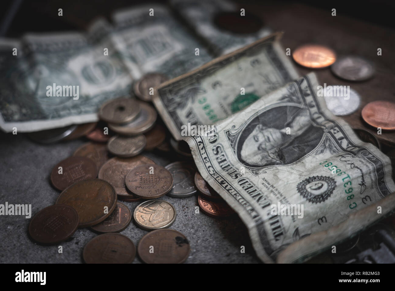 Coins and dollar bills scattered on concrete table. Money and economy ...
