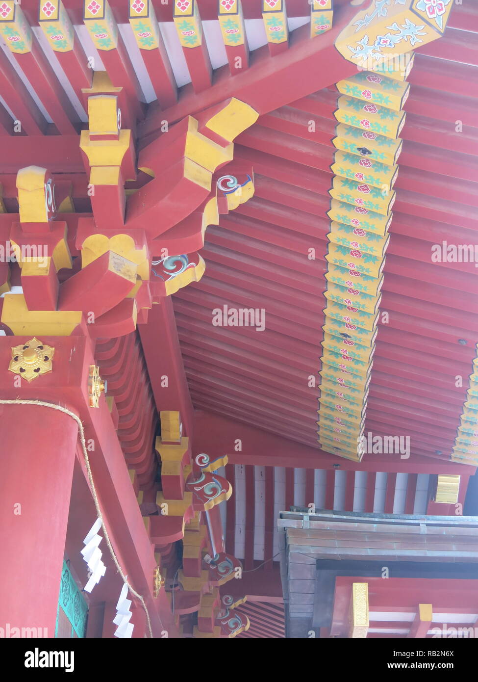 Close-up of the ornately decorated, red wooden roof structure on the ...