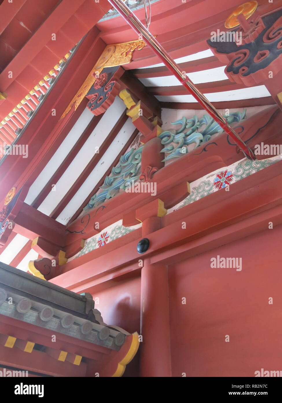 Close-up of the ornately decorated, red wooden roof structure on the ...