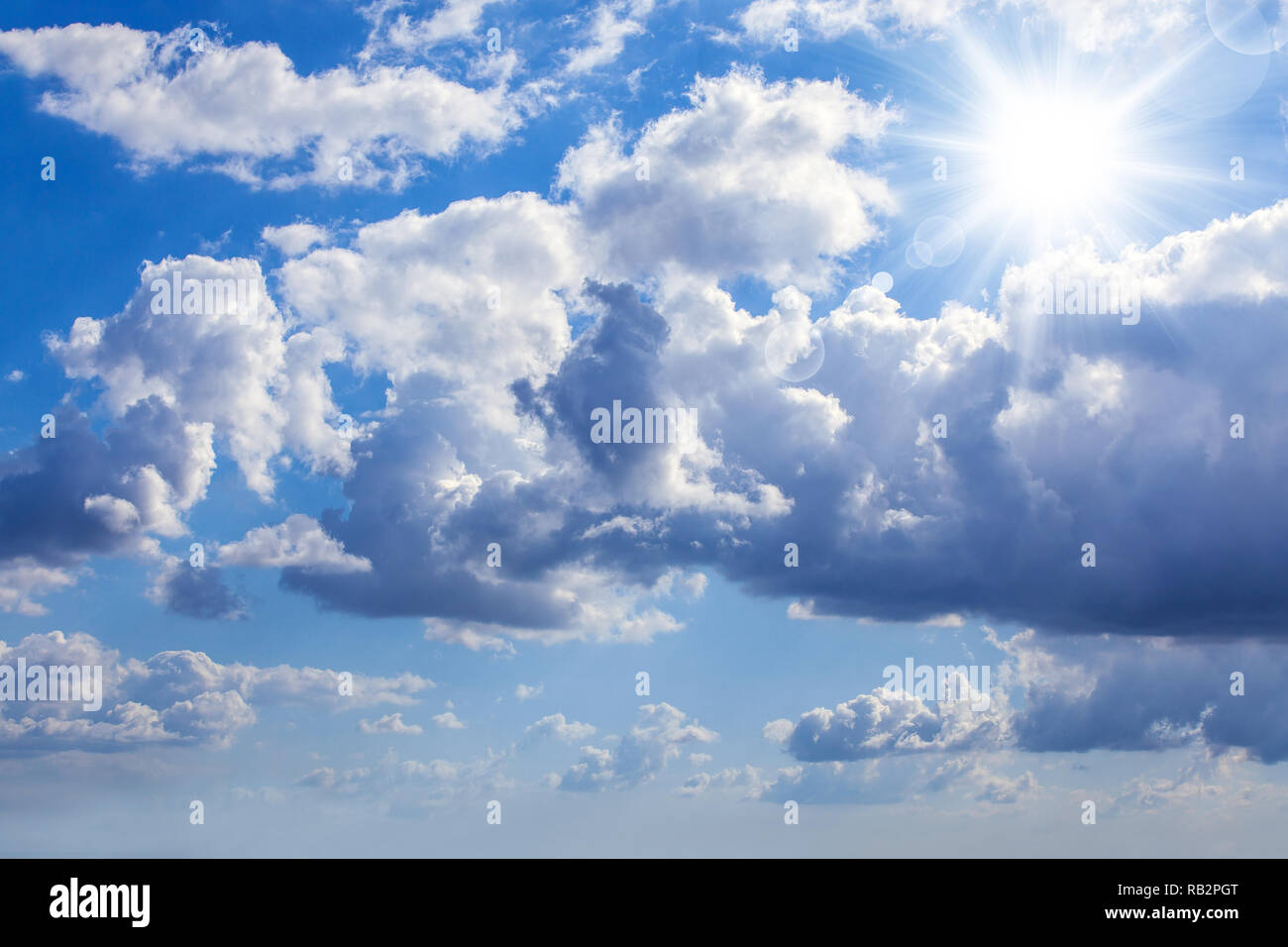 blue sky with sun, sunbeams and clouds Stock Photo - Alamy