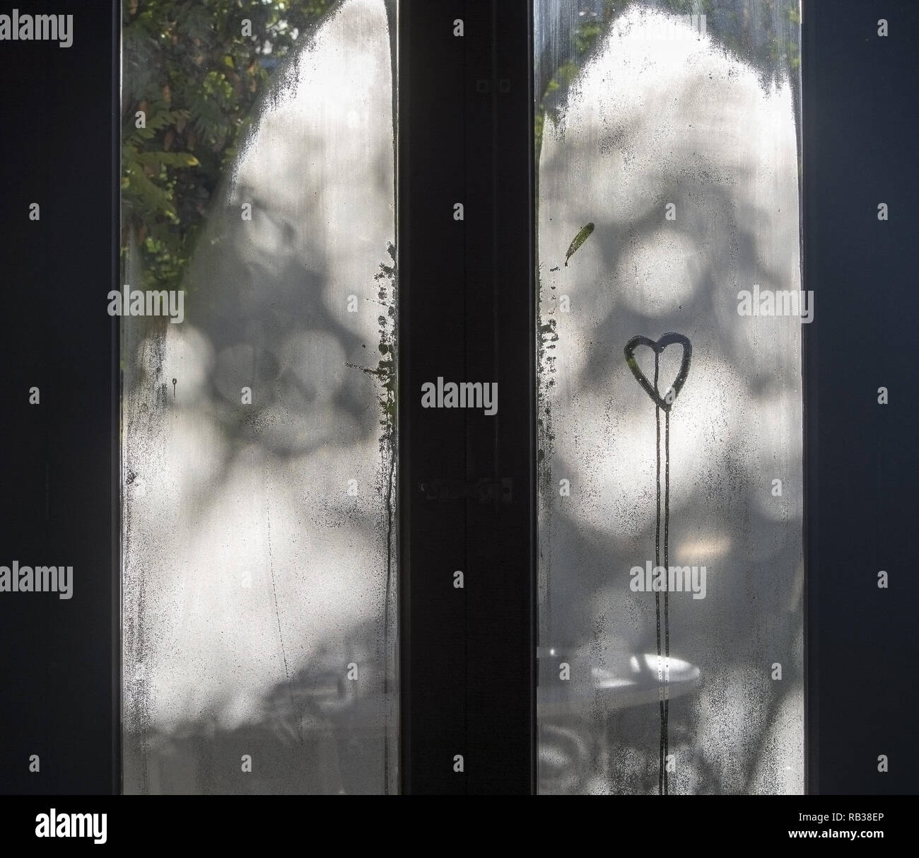 Window dew and drawn heart shape with running drops Stock Photo - Alamy