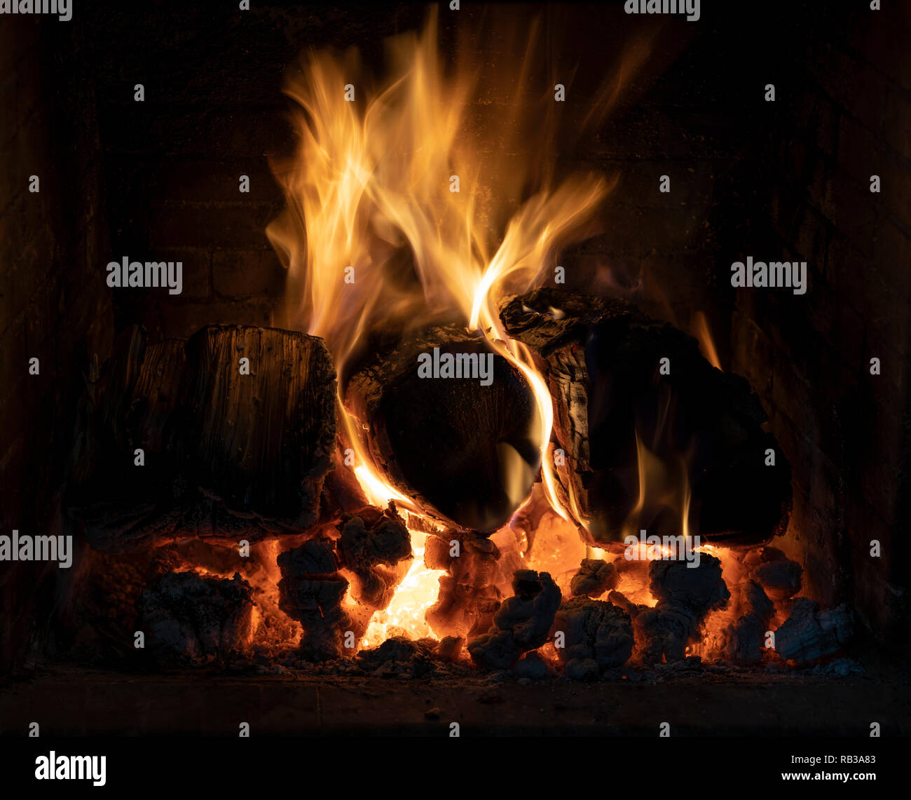 A blazing log fire in an open fireplace Stock Photo - Alamy