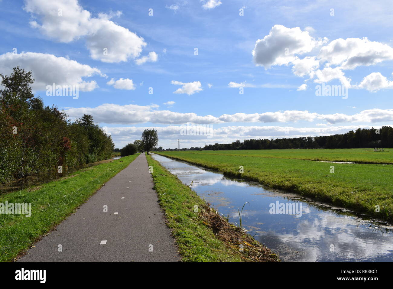 Country road beside water channel in Netherlands Stock Photo - Alamy