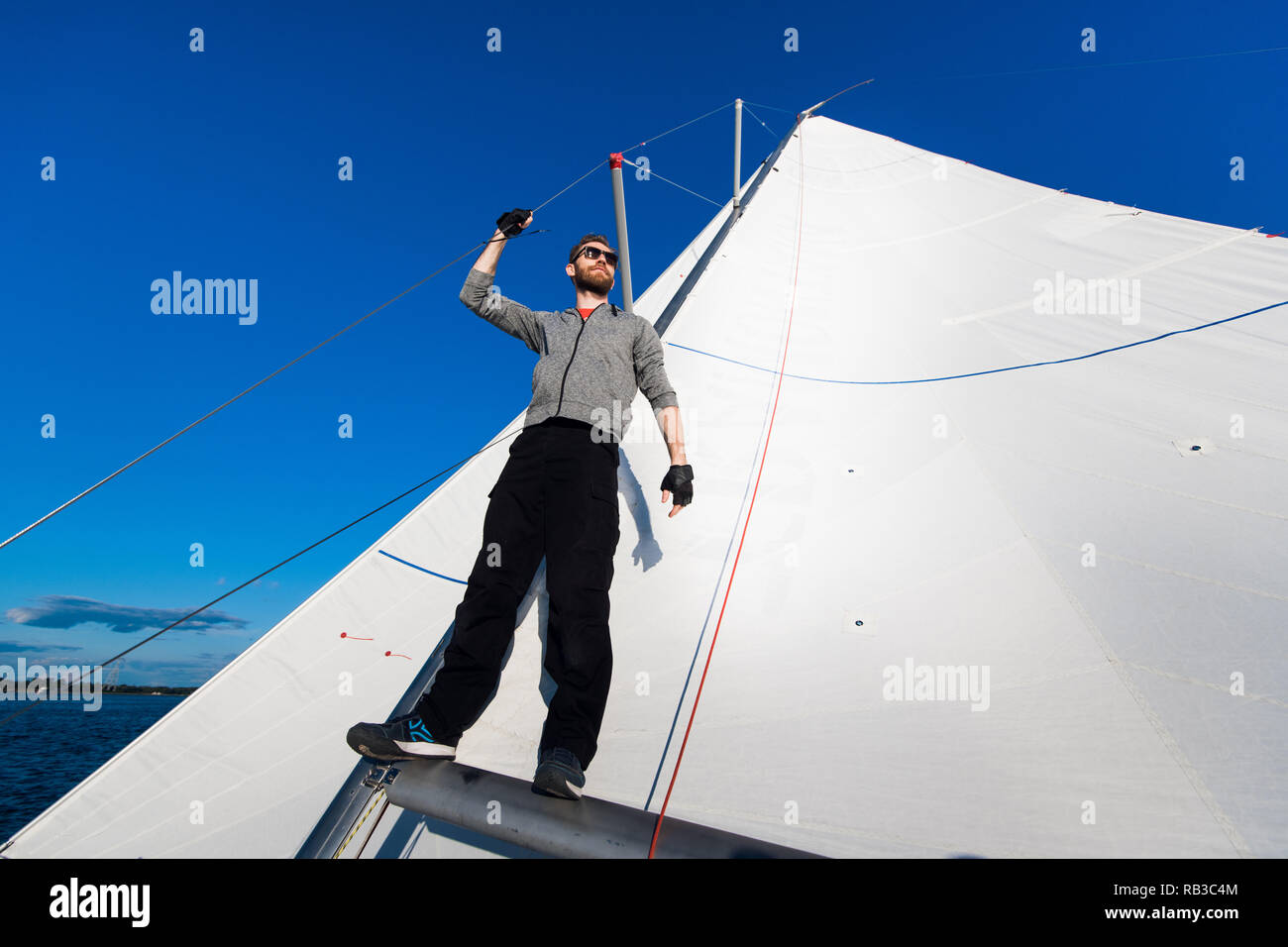 confident captain of sail boat standing and looking out to sea Stock ...