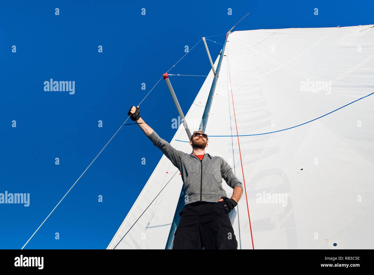 confident captain of sail boat standing and looking out to sea Stock ...