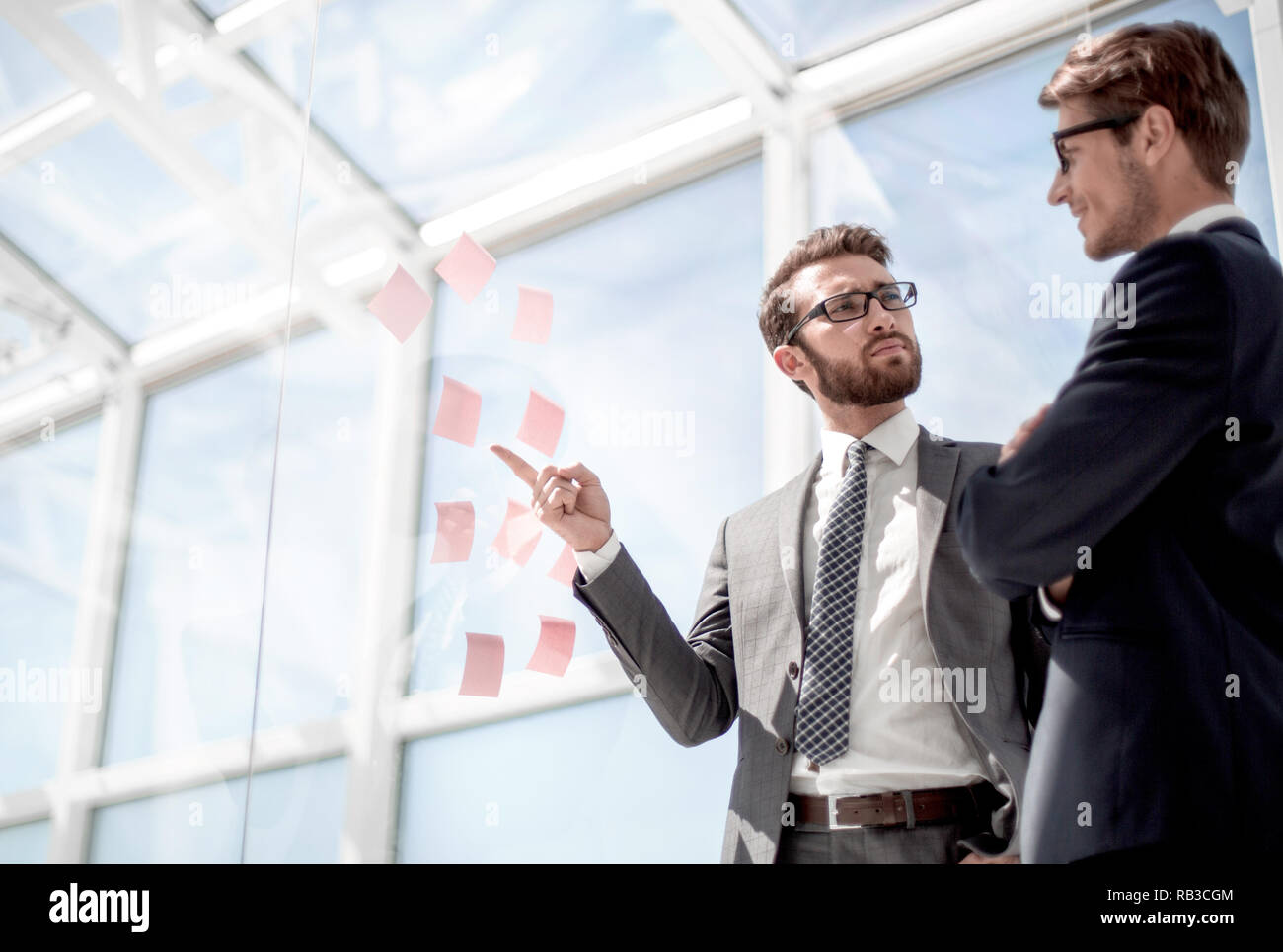 Manager points the employee to the stickers on the glass Stock Photo ...