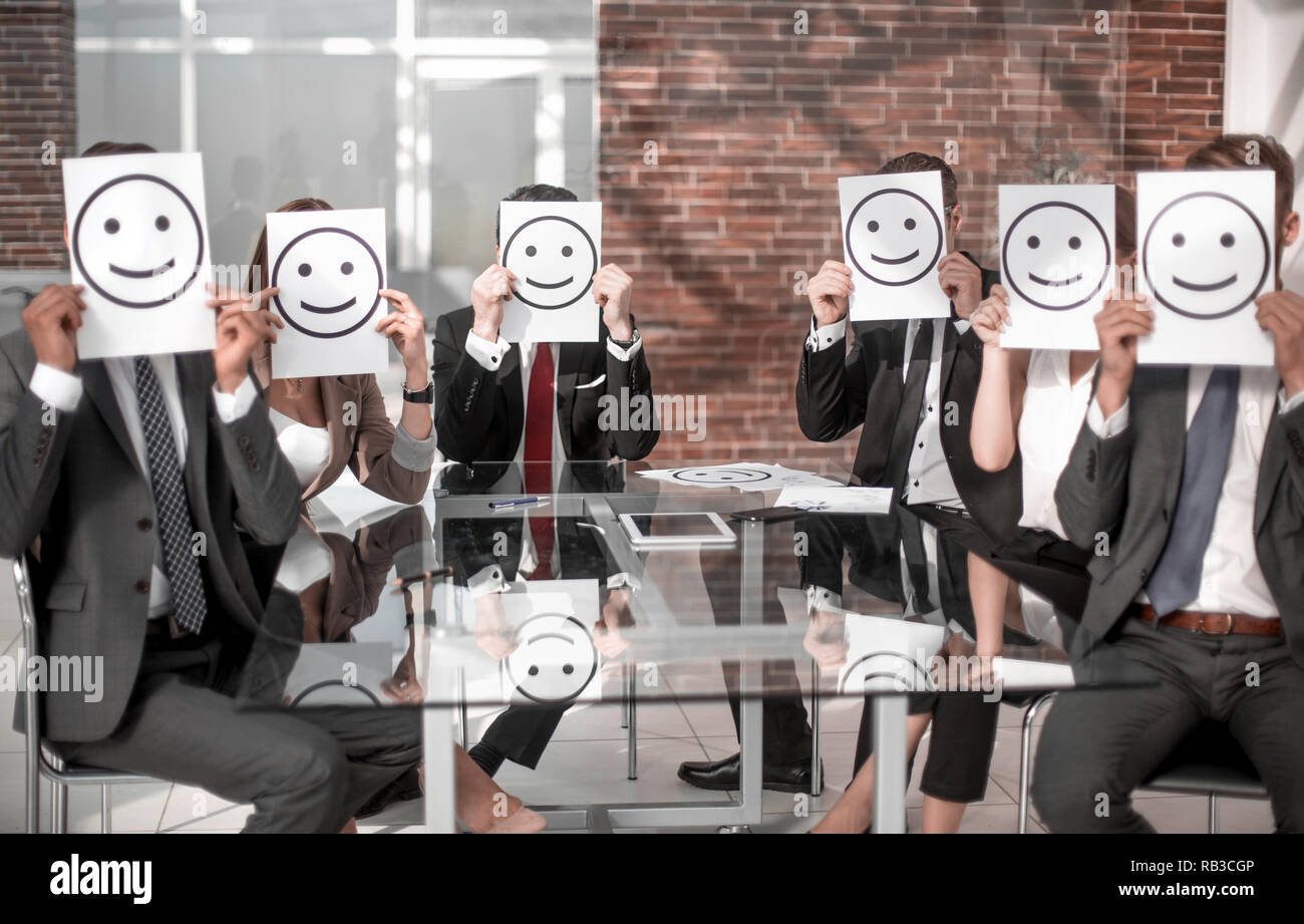 business team keeps smiley icons sitting at the Desk Stock Photo - Alamy
