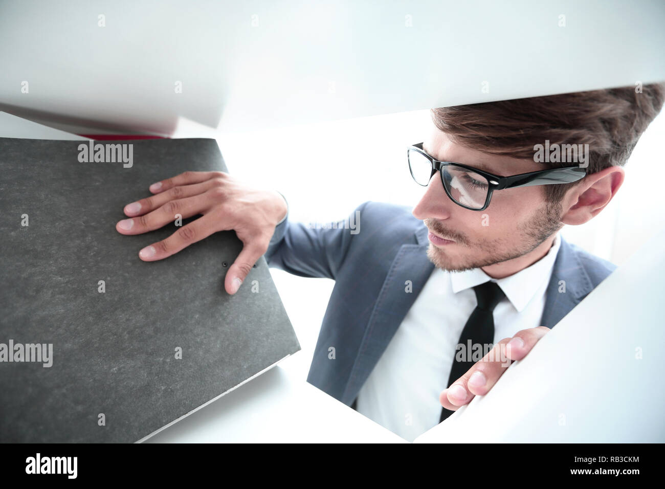 smiling man looking at documents Stock Photo - Alamy