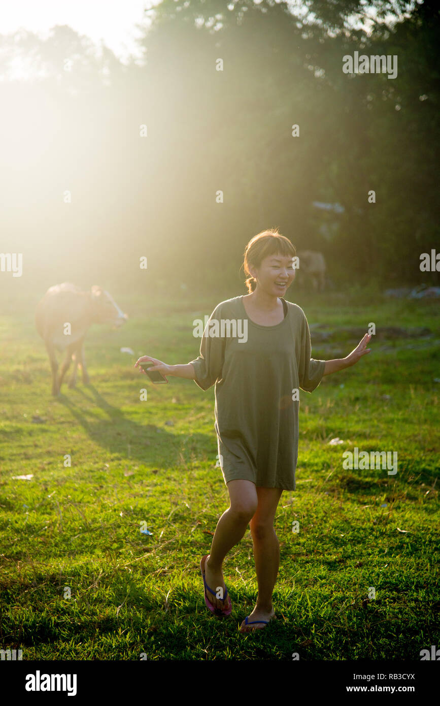 Asian female model poses for pictures in the nature Stock Photo - Alamy