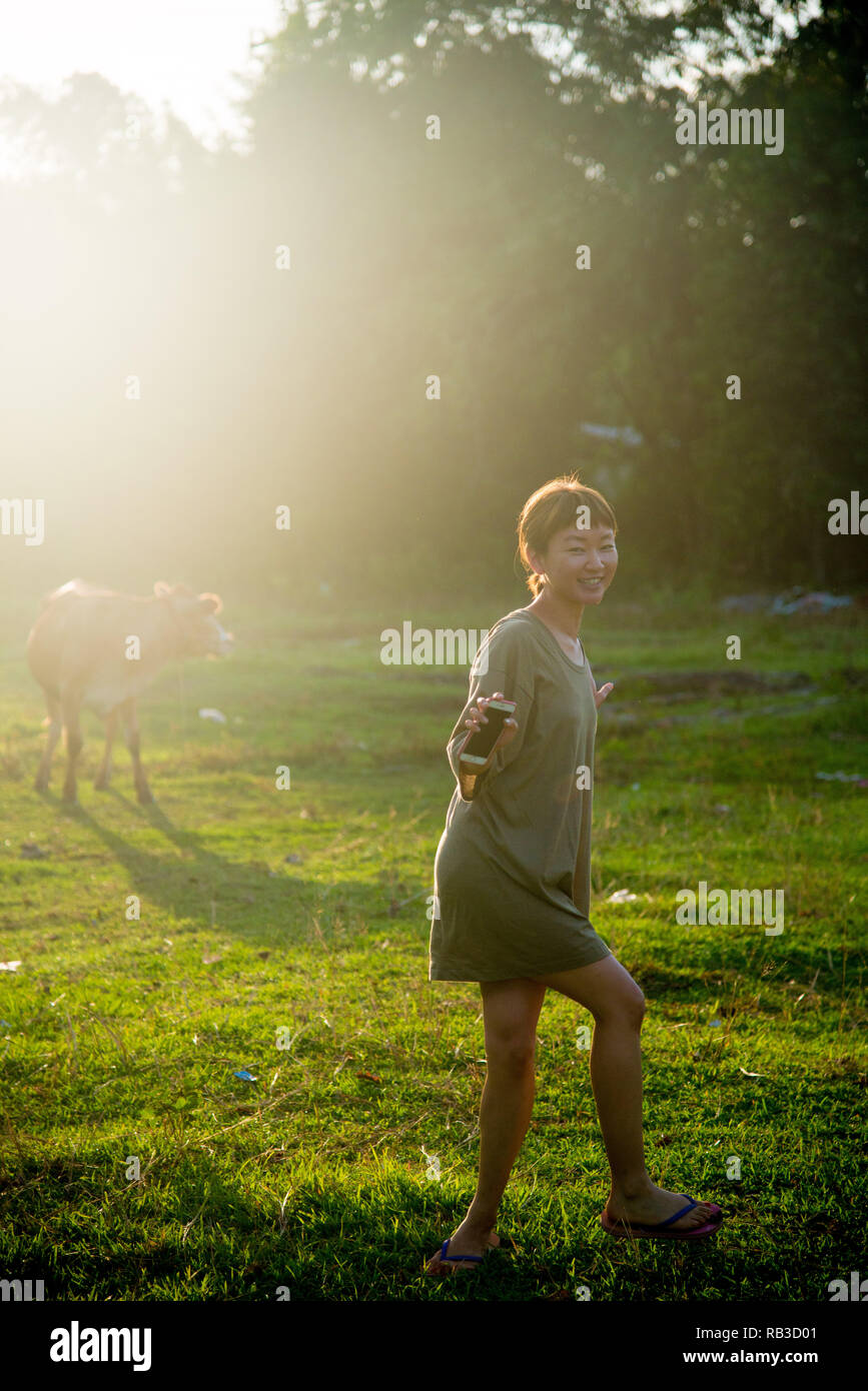 Asian female model poses for pictures in the nature Stock Photo - Alamy