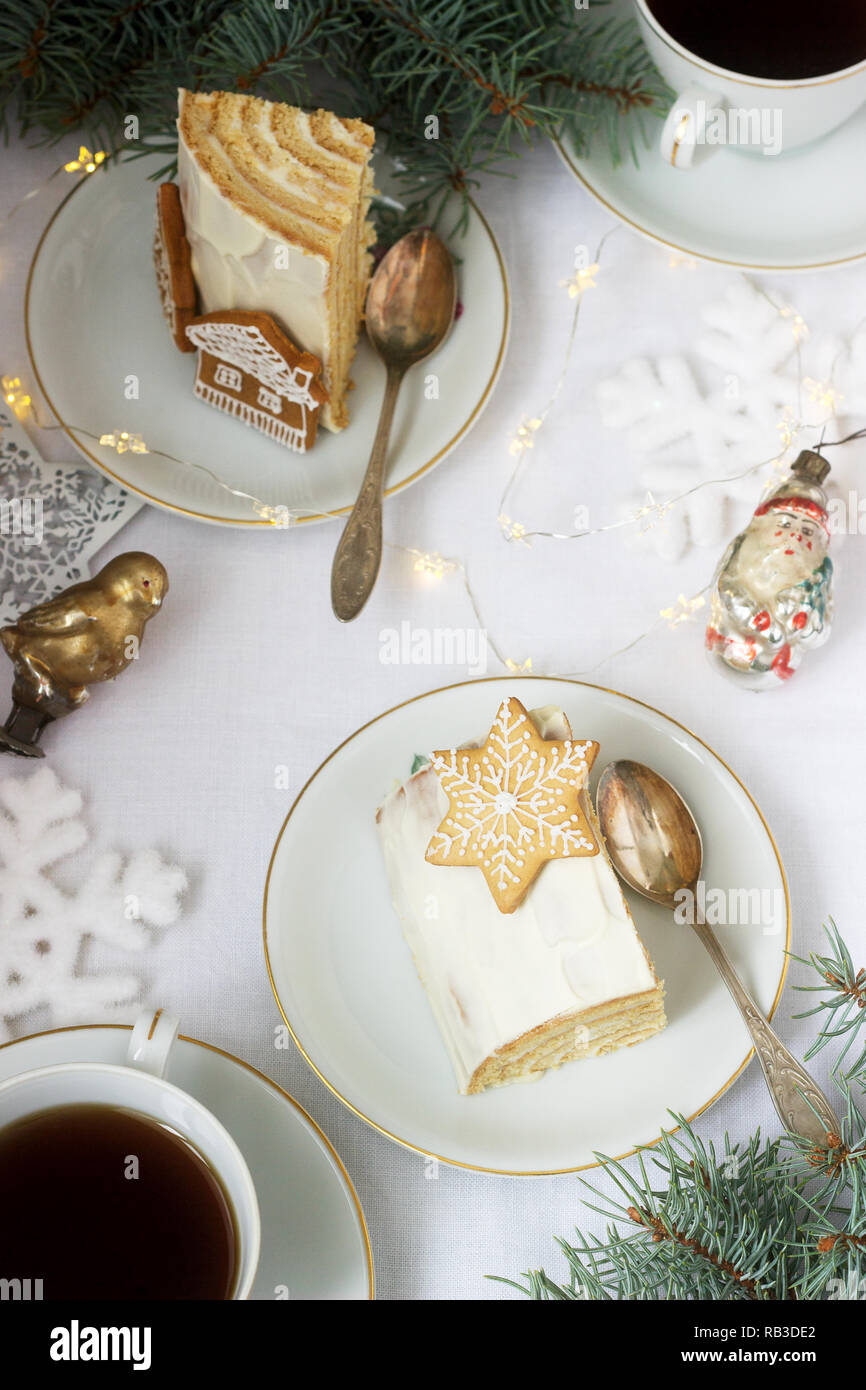 Homemade honey cake with sour cream, decorated with gingerbread. Rustic ...