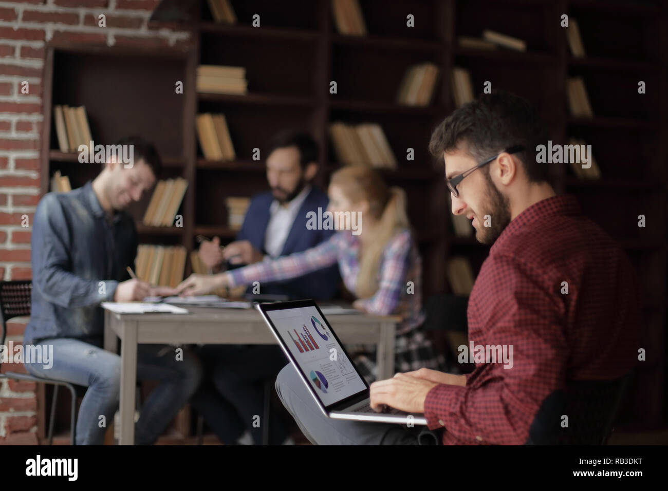 Manager creates a chart on the laptop.photo on blurred Studio ...