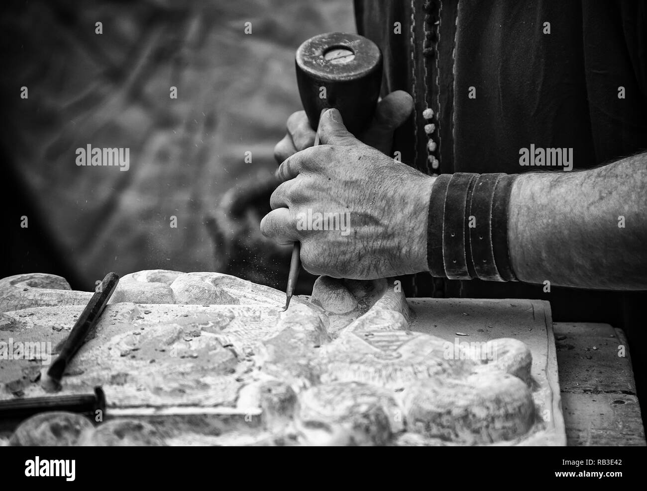 Carving stone in a traditional way, craftsmanship detail, shaping the ...