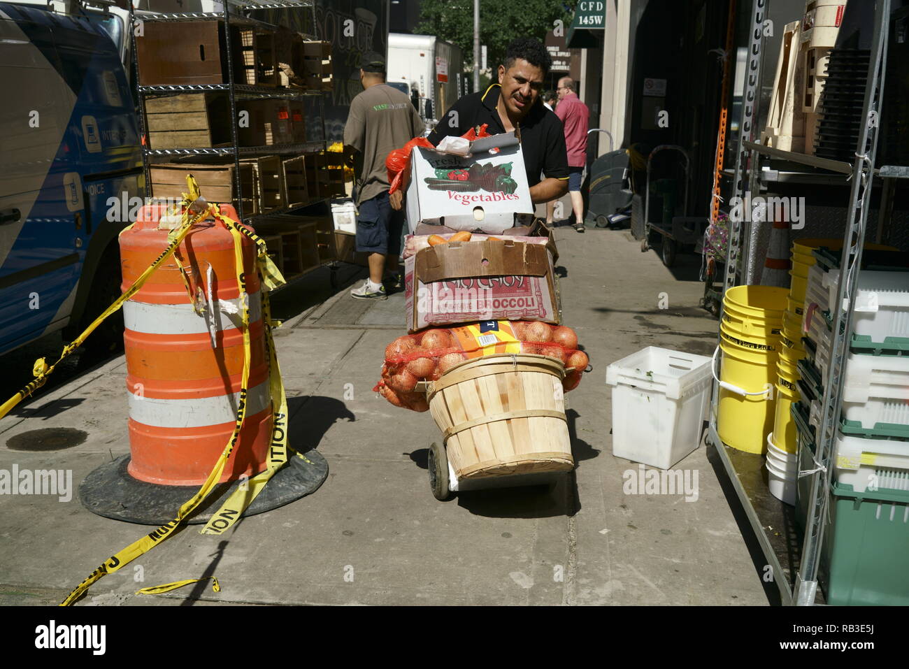 A delivery man deliver vegetables to restaurant on street of midtown ...