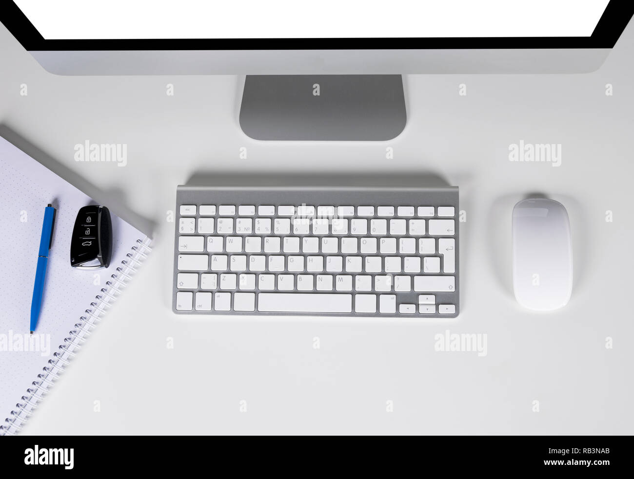 Workplace with computer and wireless keyboard and mouse, notebook and ...