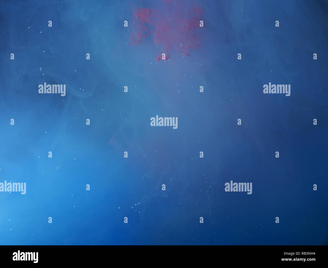 Blue paint is mixed with water. The dissolution of ink in water ...