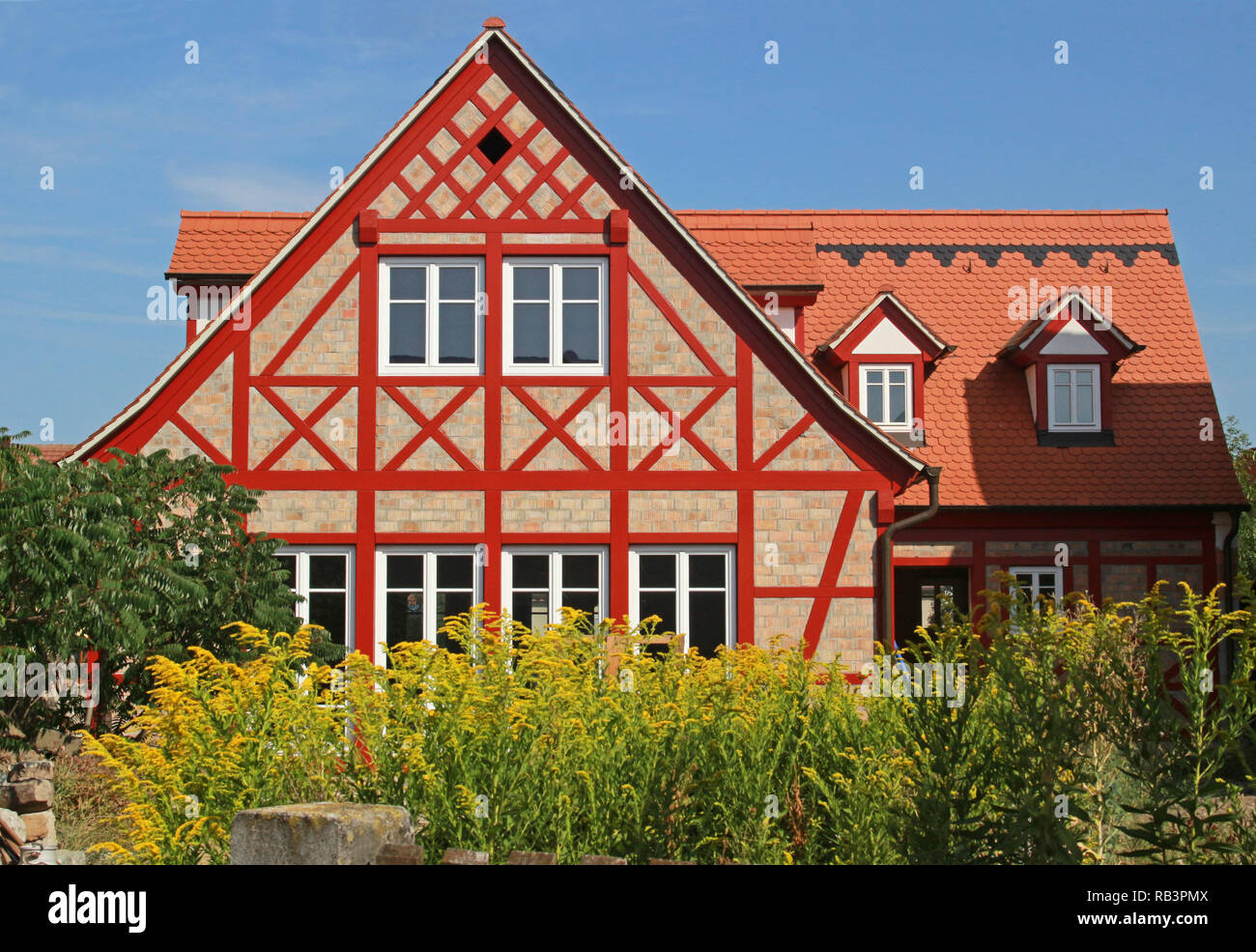 beautiful timbered house with red beams in construction, render still ...