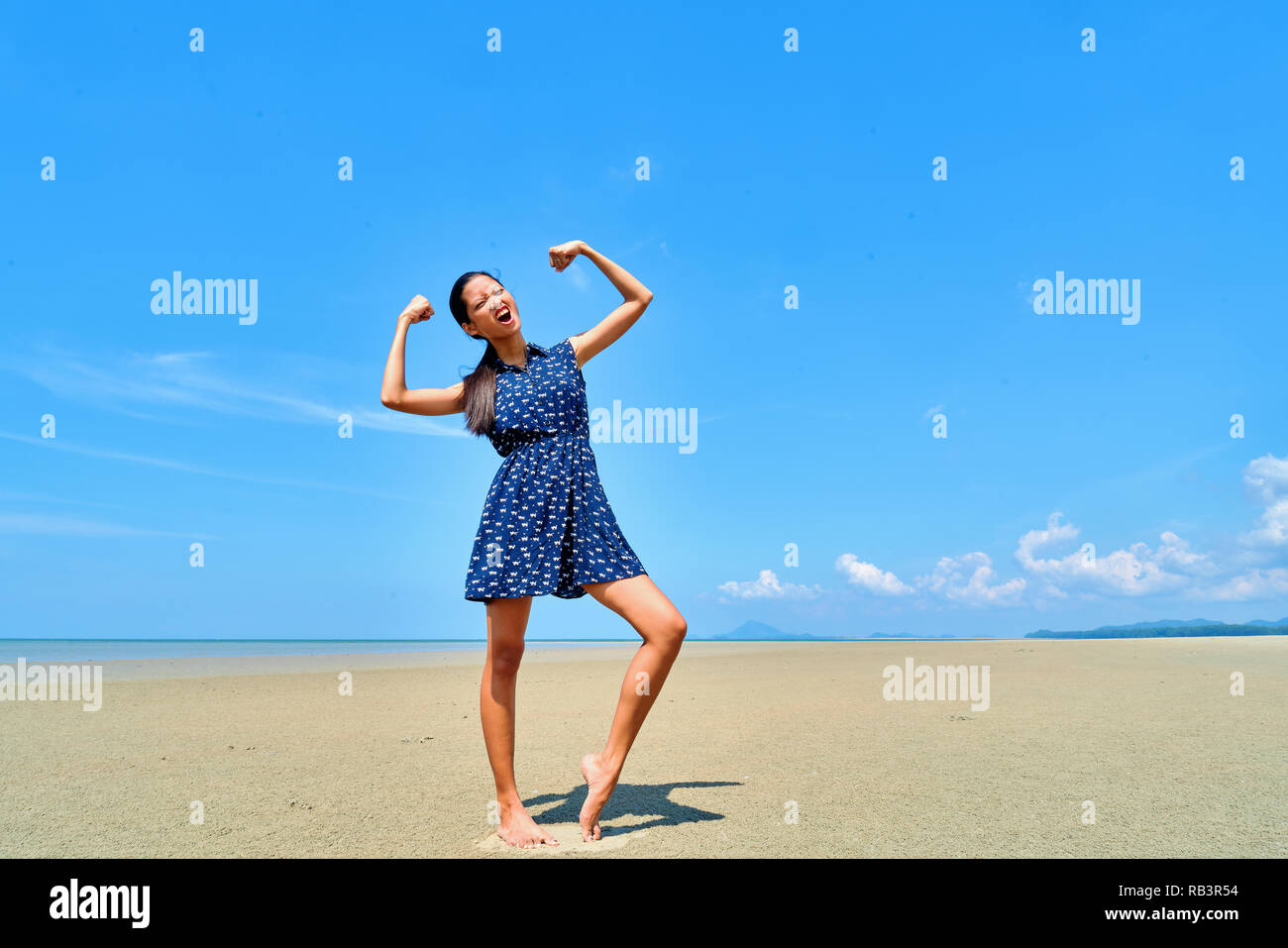 Beautiful woman posing - making a face and showing strength Stock Photo ...