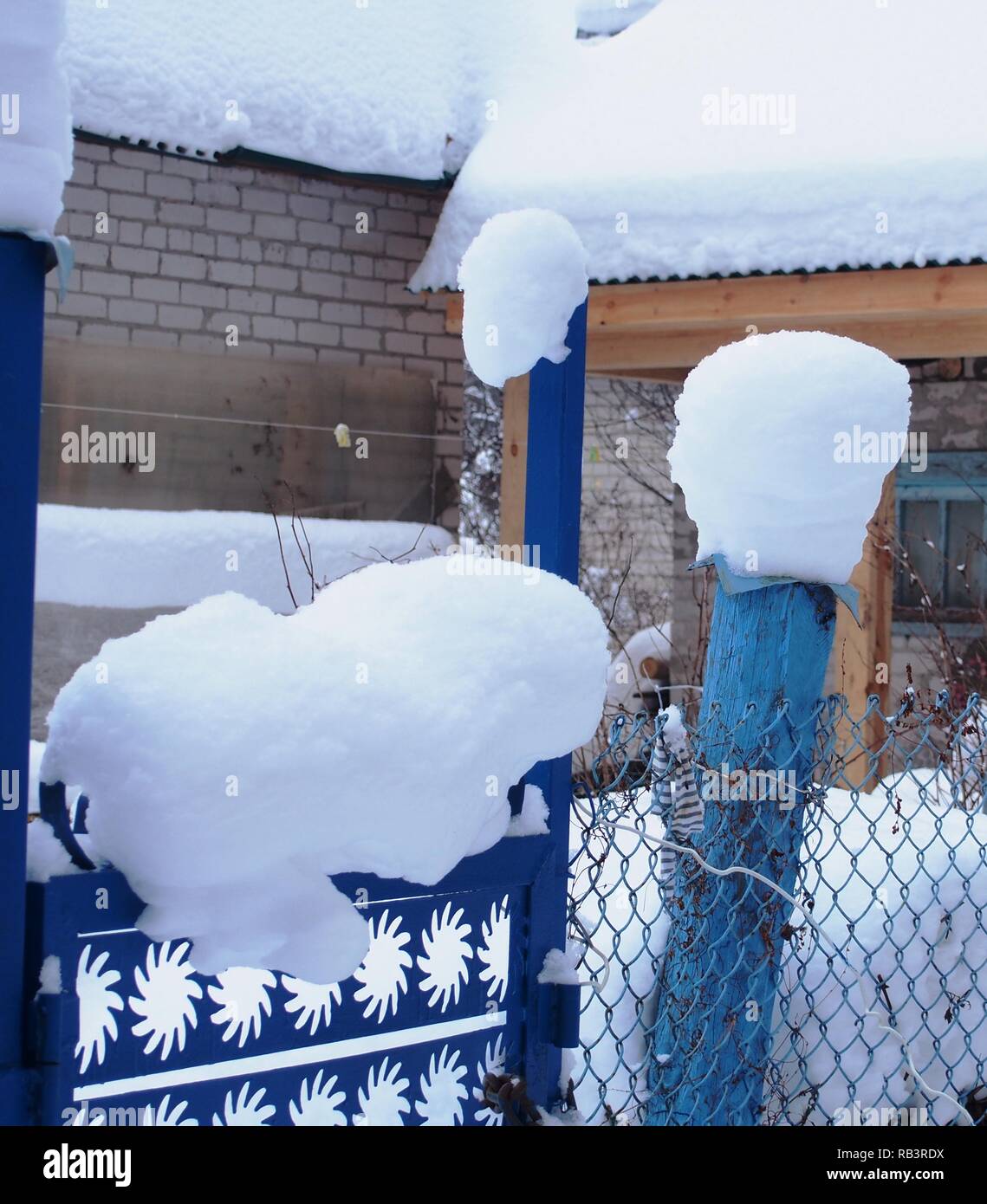 Snow caps lying on the fence posts. After a heavy snowfall. Winter ...