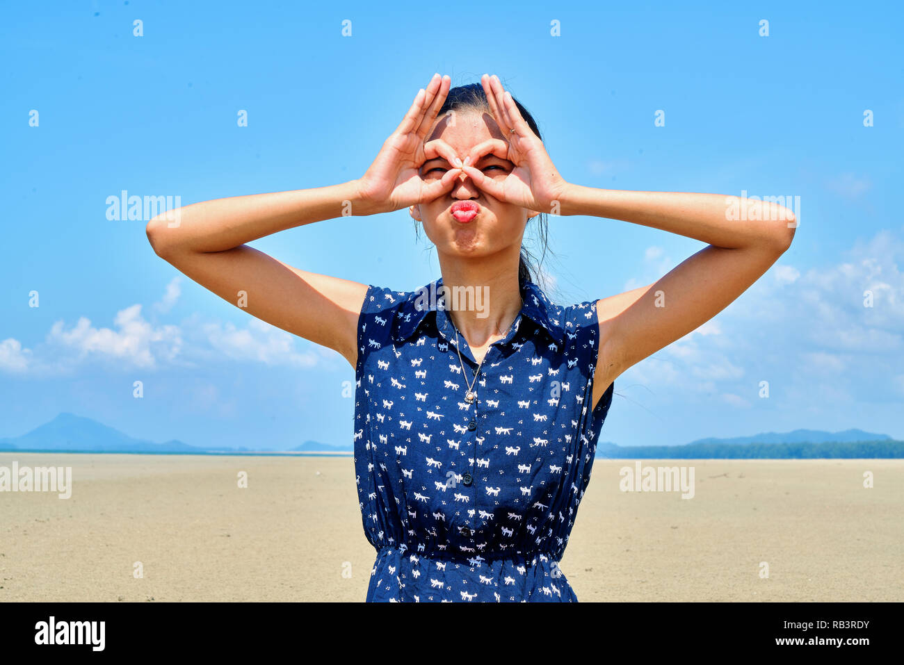 Beautiful woman posing - making a face, pouting and ok sign gesture ...