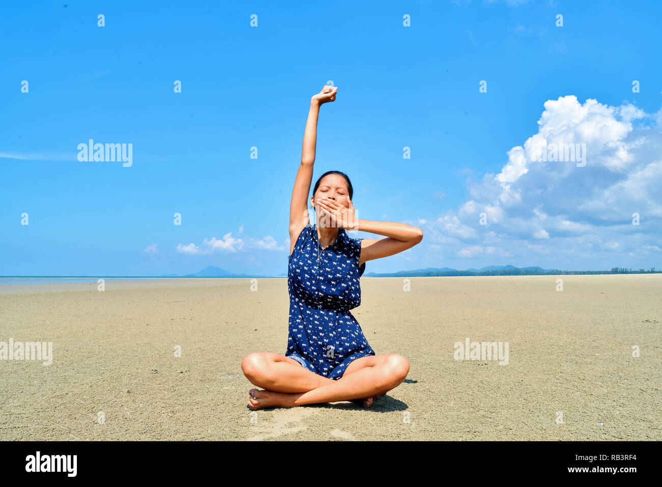 Beautiful woman posing - sitting, tired and yawning Stock Photo - Alamy