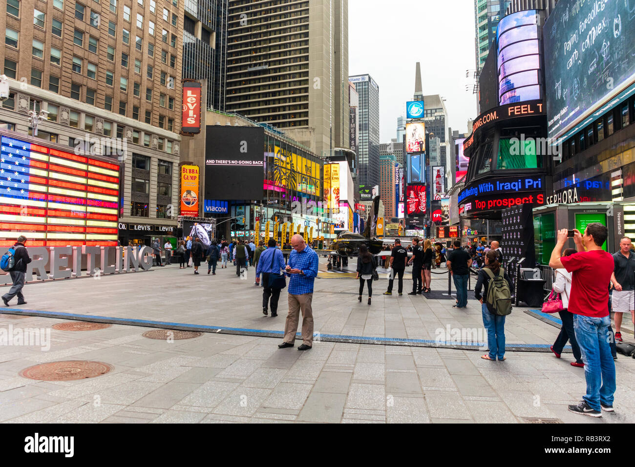 Pedestrians walk through times square hi-res stock photography and ...
