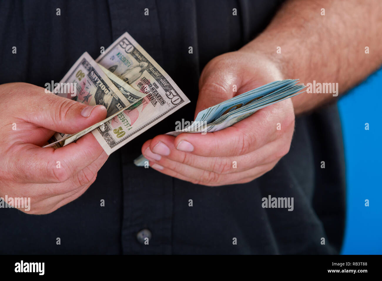 Counting US currency man counts money dollars in hands Close up view ...