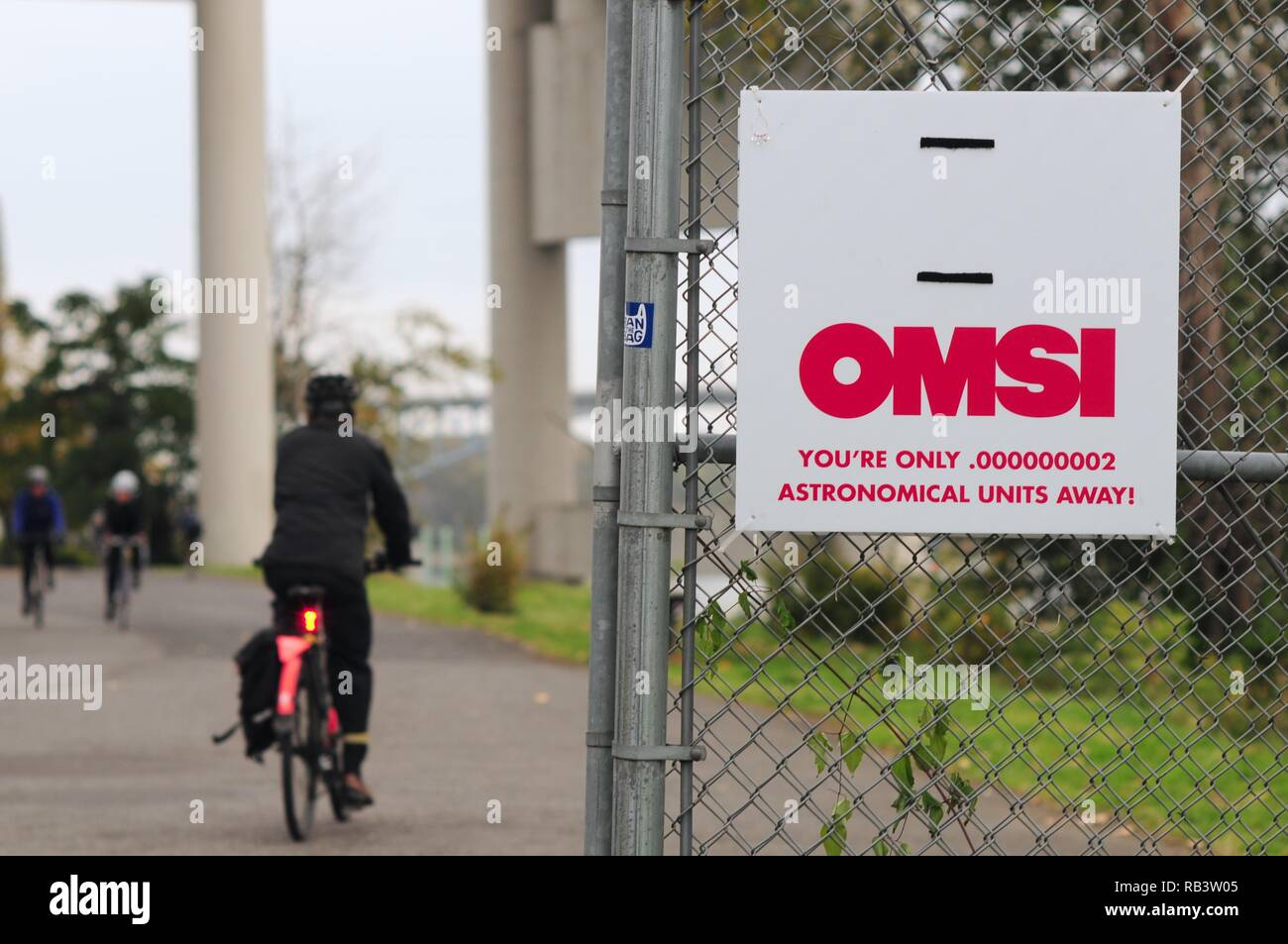 A sign for OMSI (Oregon Museum of Science and Industry) on a metal gate ...