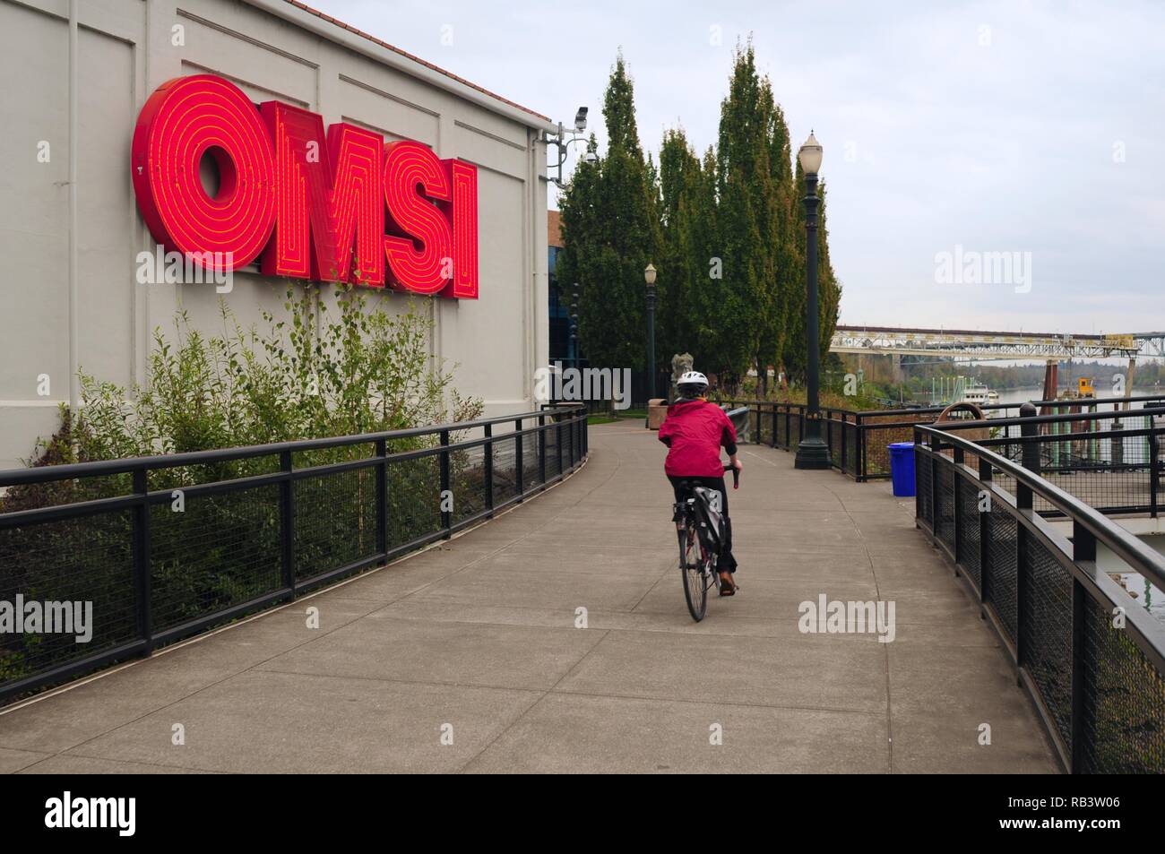 A bicyclist going by a OMSI (Oregon Museum of Science and Industry ...