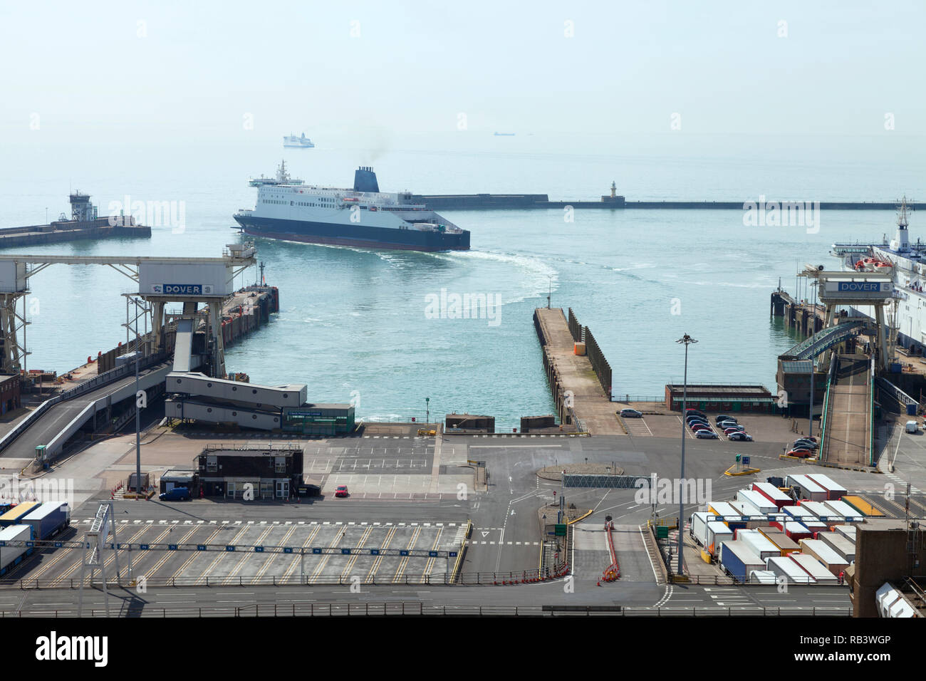 Ferry entering Port of Dover terminal. Lorries and cars waiting for ...