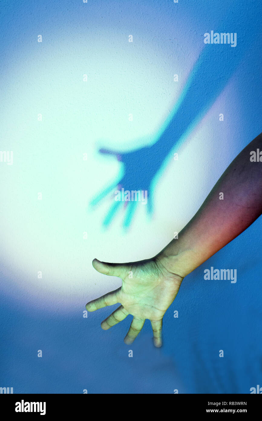 Extended arm with shadow in color, feeling of loneliness Stock Photo ...