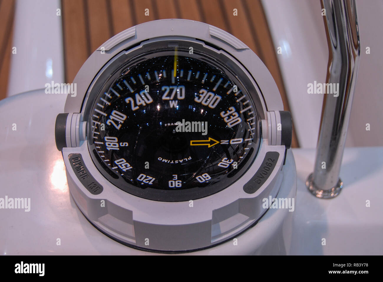 Modern yacht ship compass showing west Stock Photo - Alamy