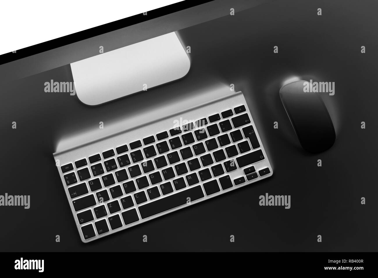 Workplace with computer and wireless keyboard and mouse on black ...