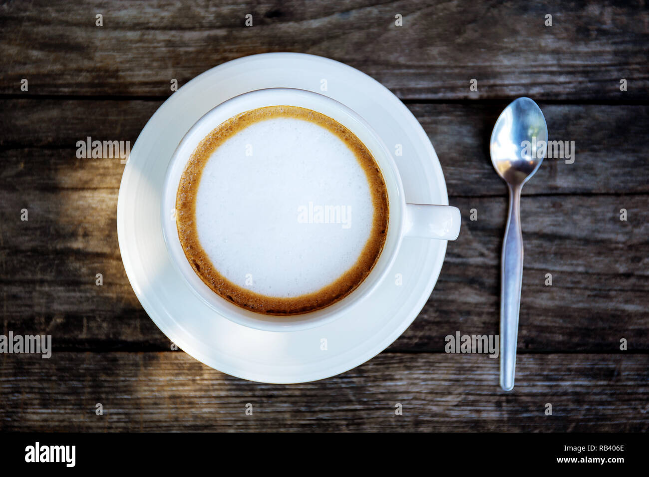 Coffee cup and spoon on wooden table with background Stock Photo - Alamy