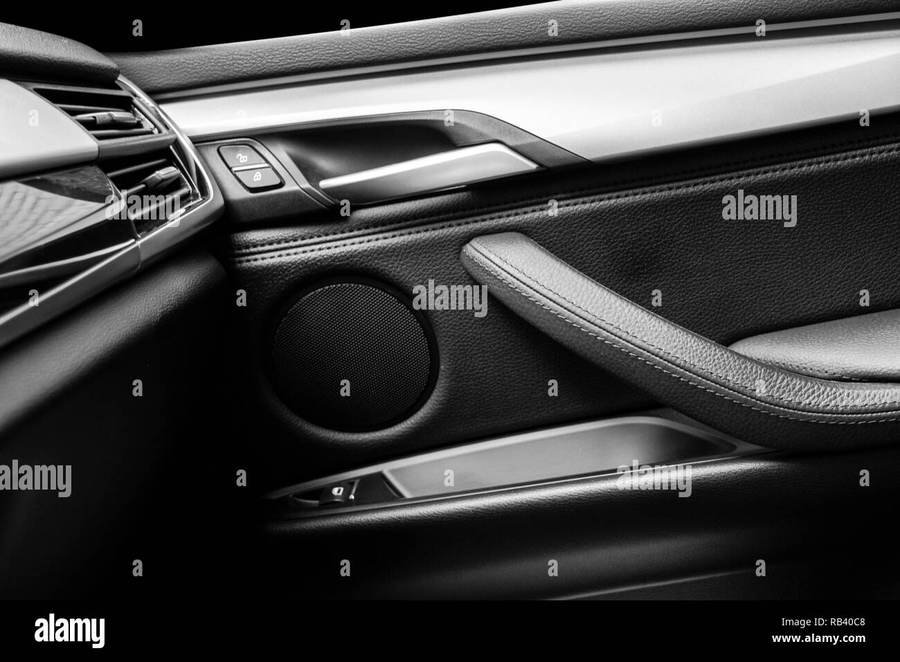 Door handle with Power window control buttons of a luxury passenger car ...