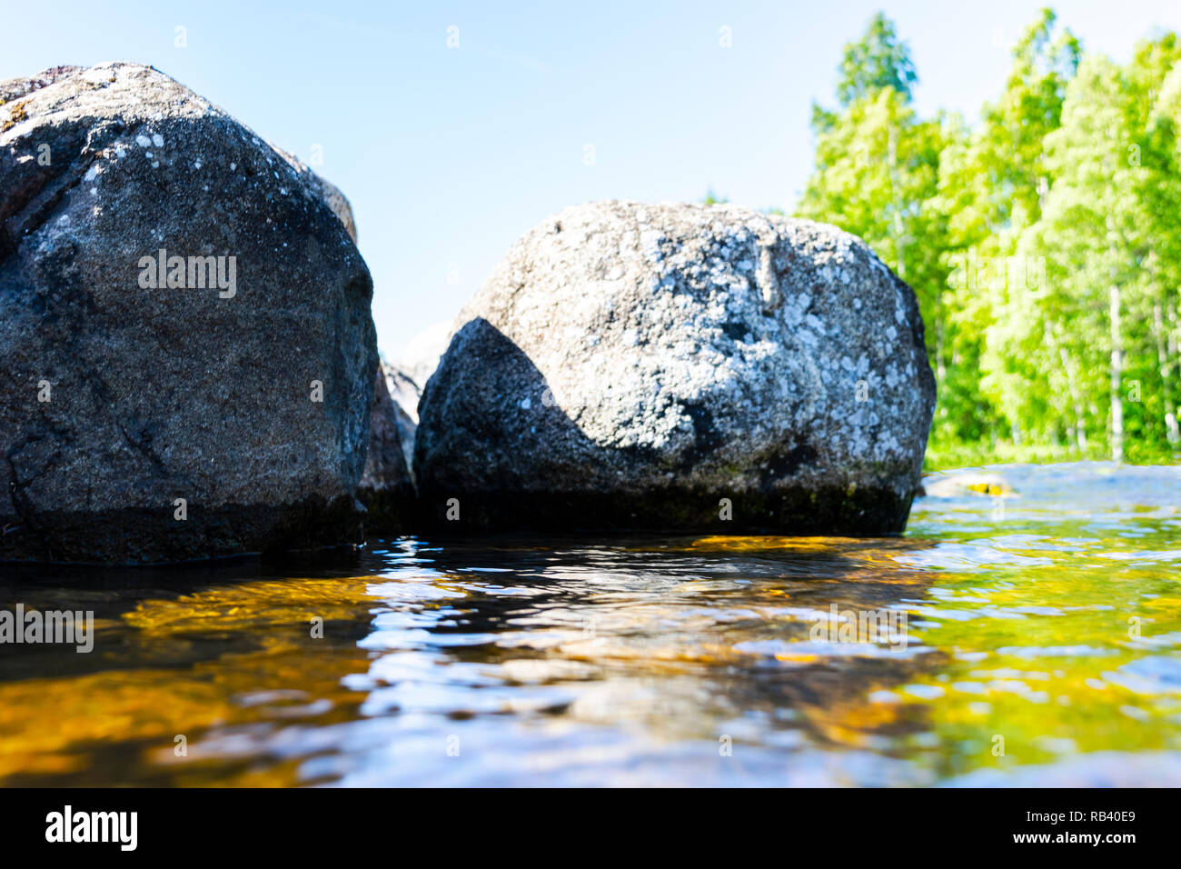 Big windy waves splashing over rocks. Wave splash in the lake against ...