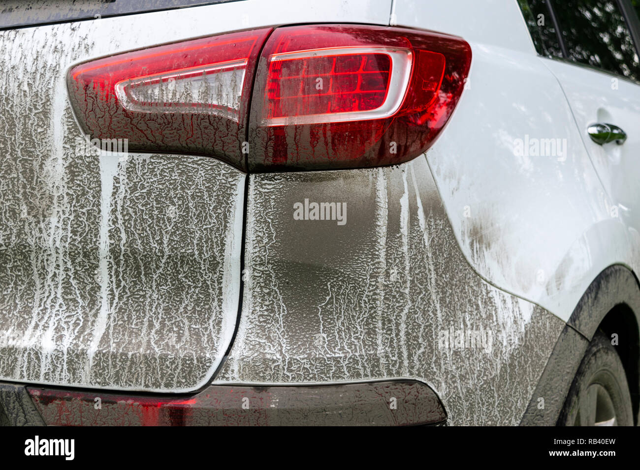 Back view of a very dirty car. Fragment of a dirty SUV. Dirty ...