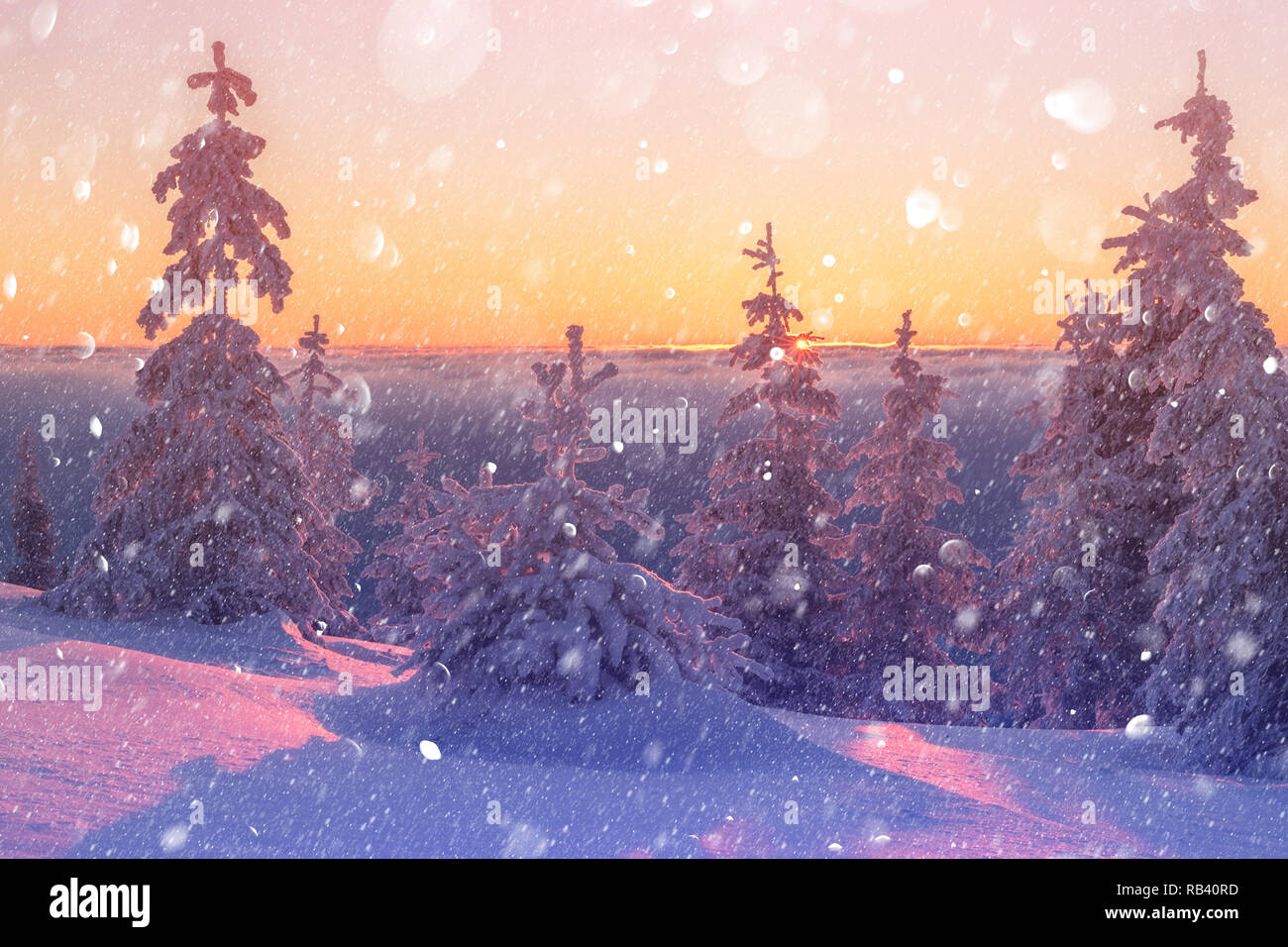 Fantastic orange winter landscape in snowy mountains glowing by sunlight. Dramatic wintry scene ...