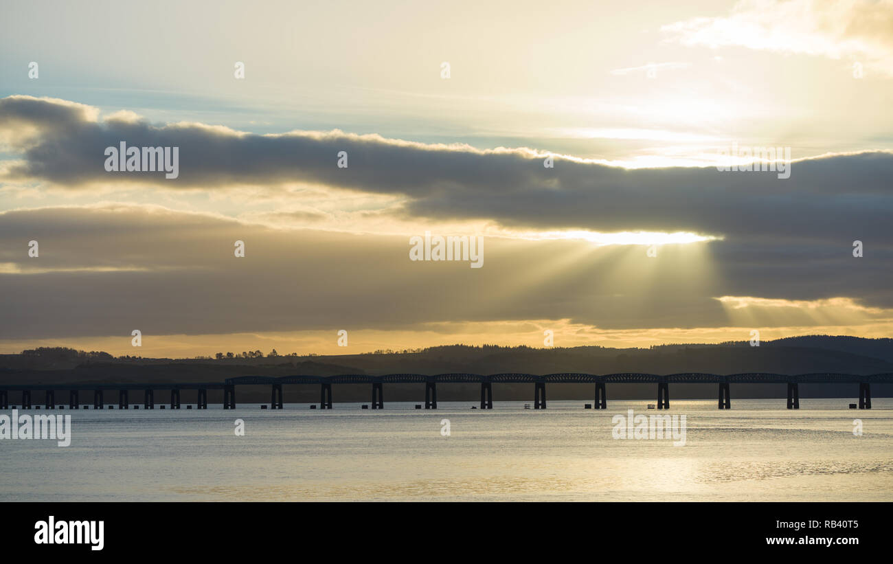 Old railroad bridge at sunset/sunrise, rays of sunlight leading way ...