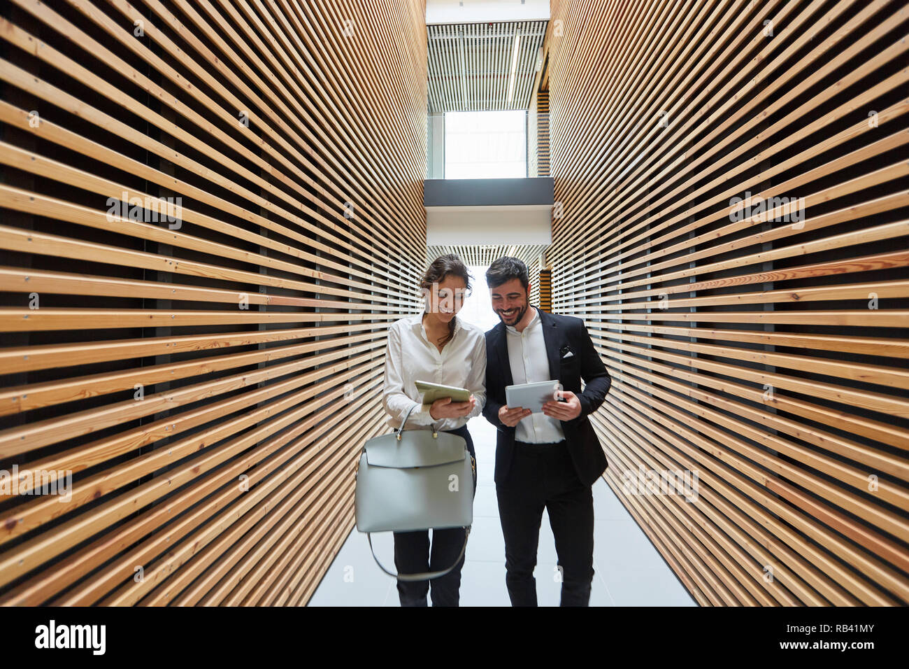 Two business people working together with tablet PC in modern office ...