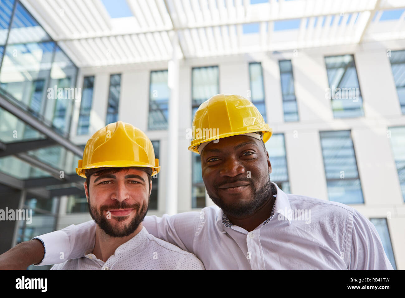 Two business people with hard hat as construction supervisor or ...