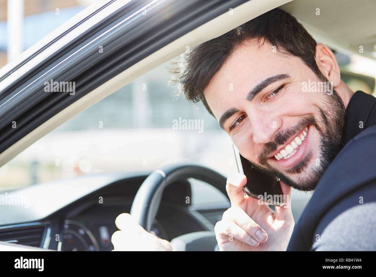 Man as a car driver when talking by mobile phone is distracted Stock ...