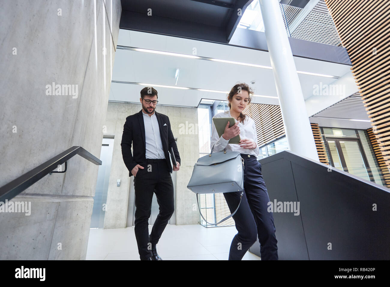 Two business people hurry on the way to work in the business group ...