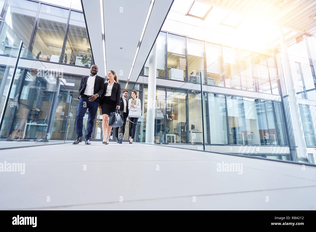 Group of business people go out together from office after work Stock ...