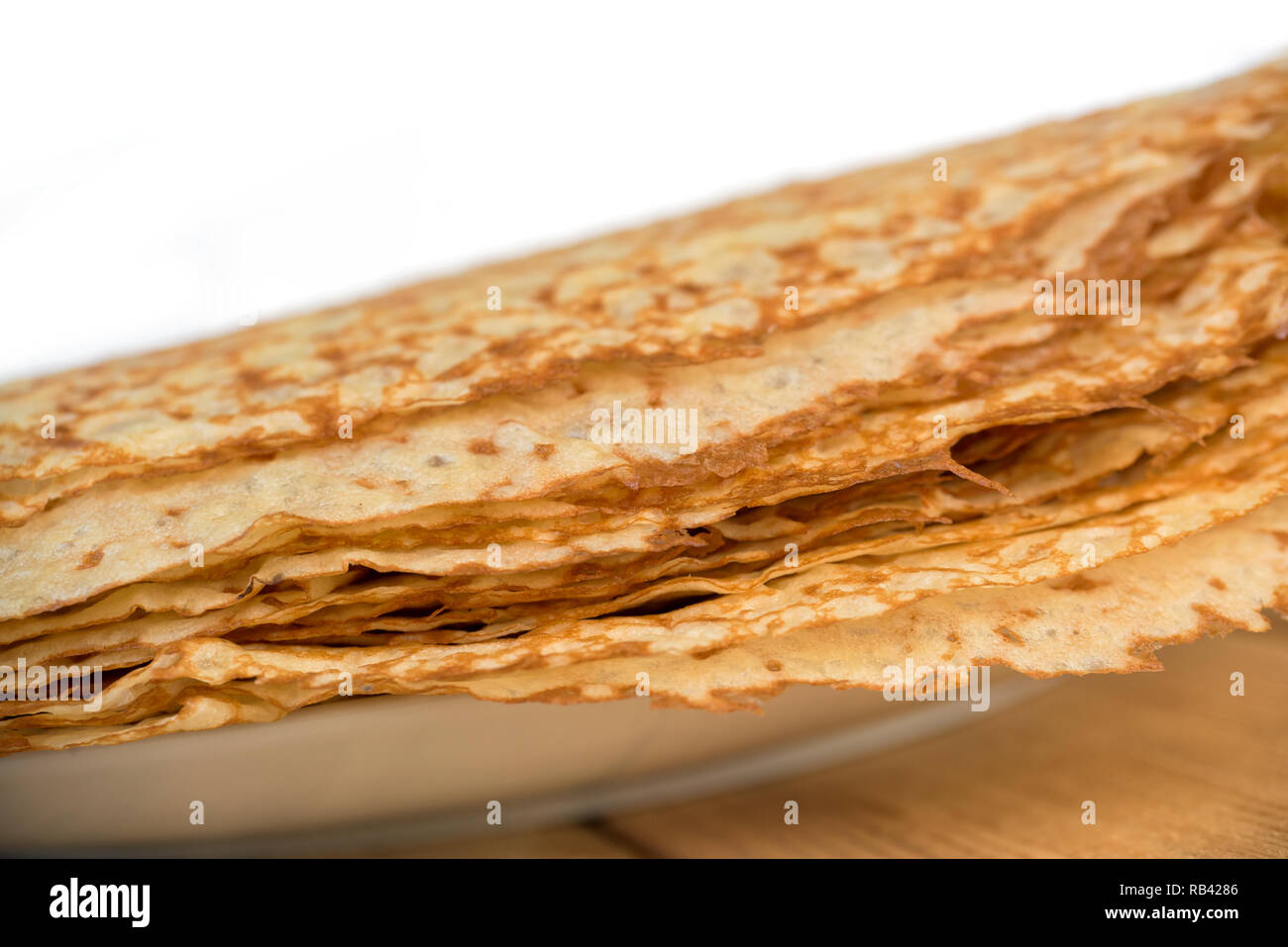 Close up on a stack of crepes (french pancakes) on a plate, white ...
