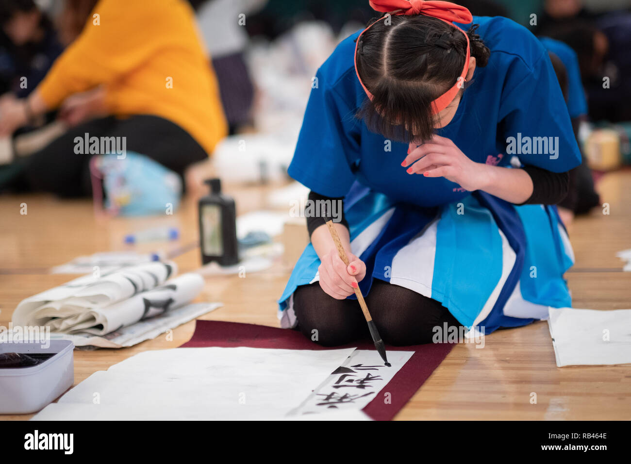 Girl works on her calligraphy as she takes part in the Kakizome ...