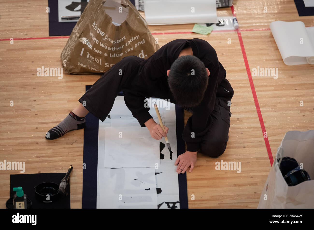 Boy works on his calligraphy as he takes part in the Kakizome ...